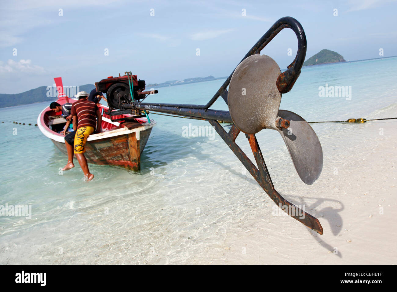 Traditional Thai long tailed boat and crew and tropical seascape on ...