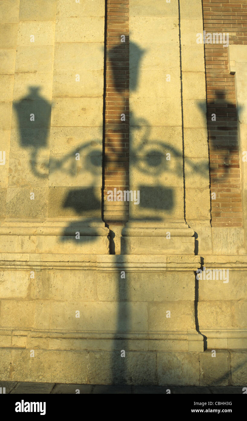 Shadow of an old street lamp on the wall of the Archivo de Indias ...