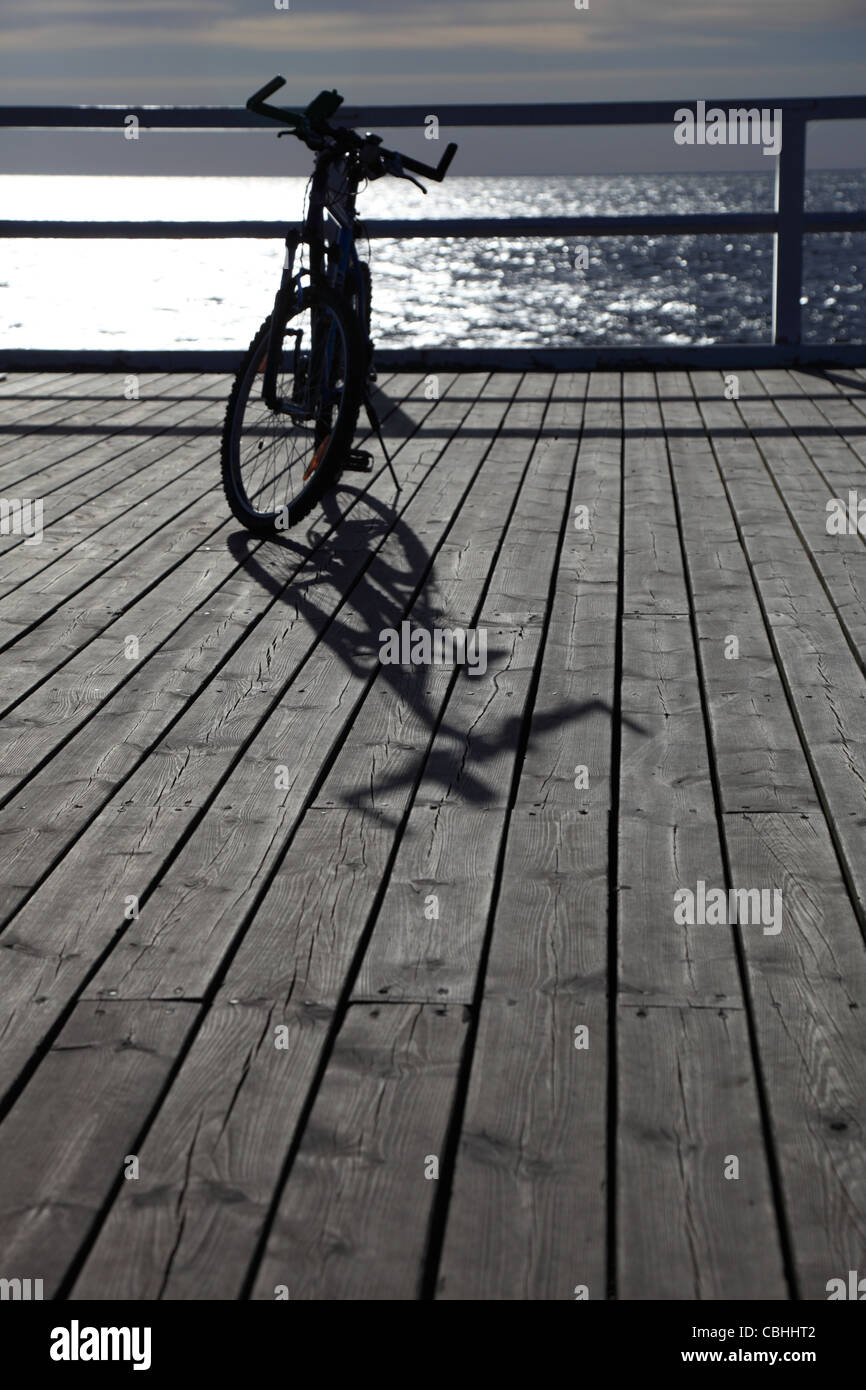 Bike at the pier, jetty in morning sea Stock Photo - Alamy
