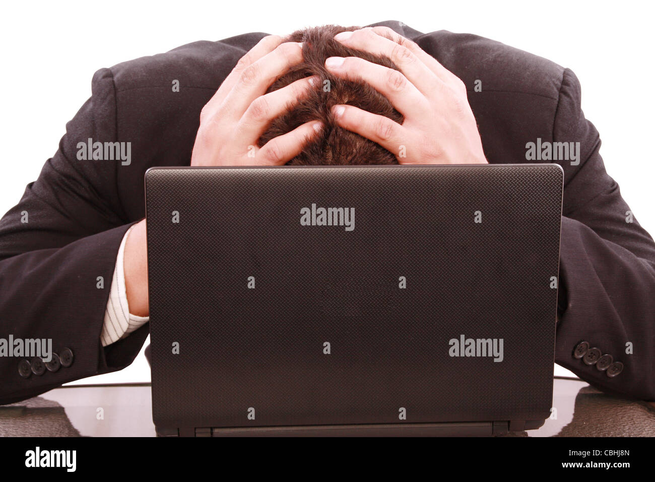 a successful business man is frustrated on a table with a laptop Stock ...