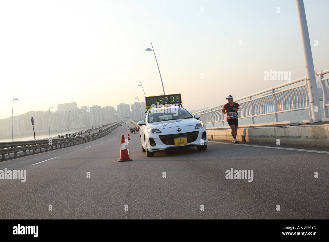 Macau marathon, clock car along with athlete, Macau Stock Photo - Alamy