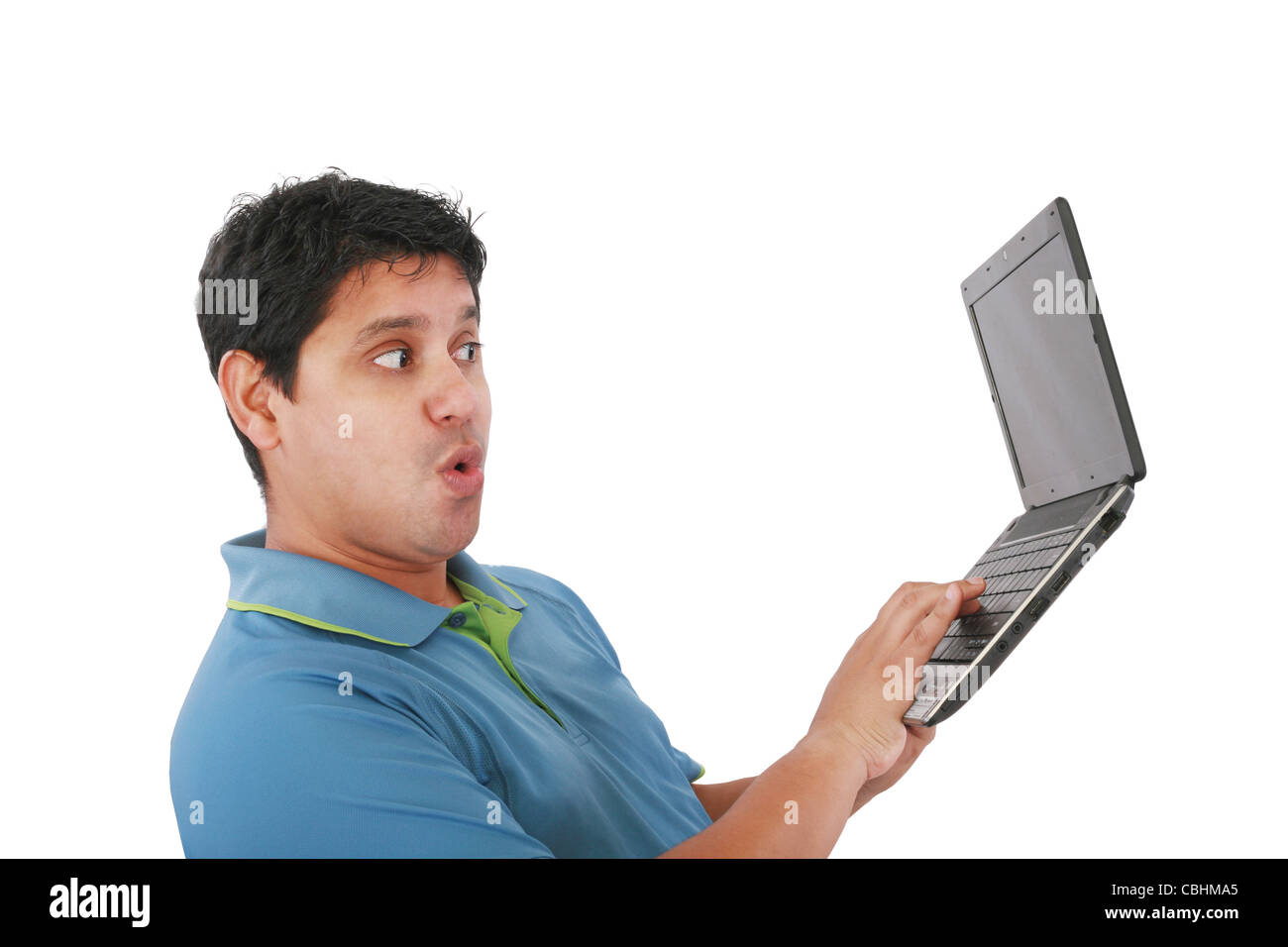 Young man standing, holding a laptop computer, working, looking down ...