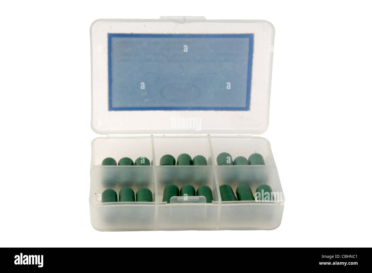 Green capsules in Pill box on white background Stock Photo - Alamy