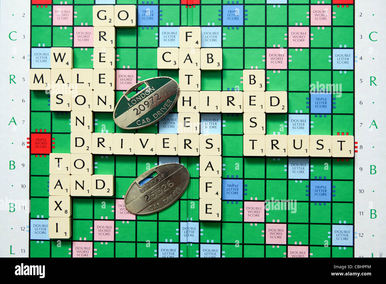 London taxi drivers badges arranged upon a scrabble board. Father and ...