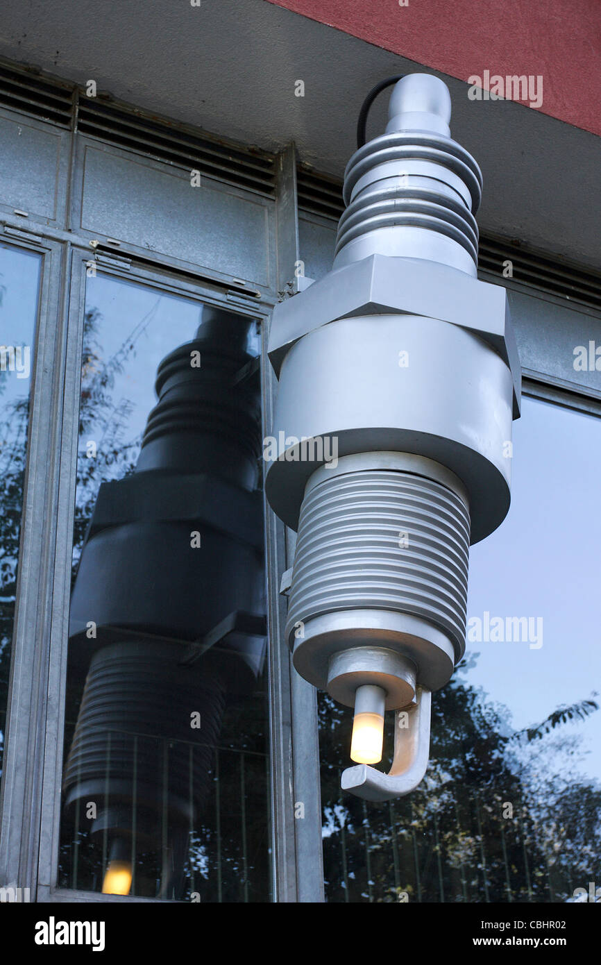 Huge spark plug attached to an office block in Islington Stock Photo ...