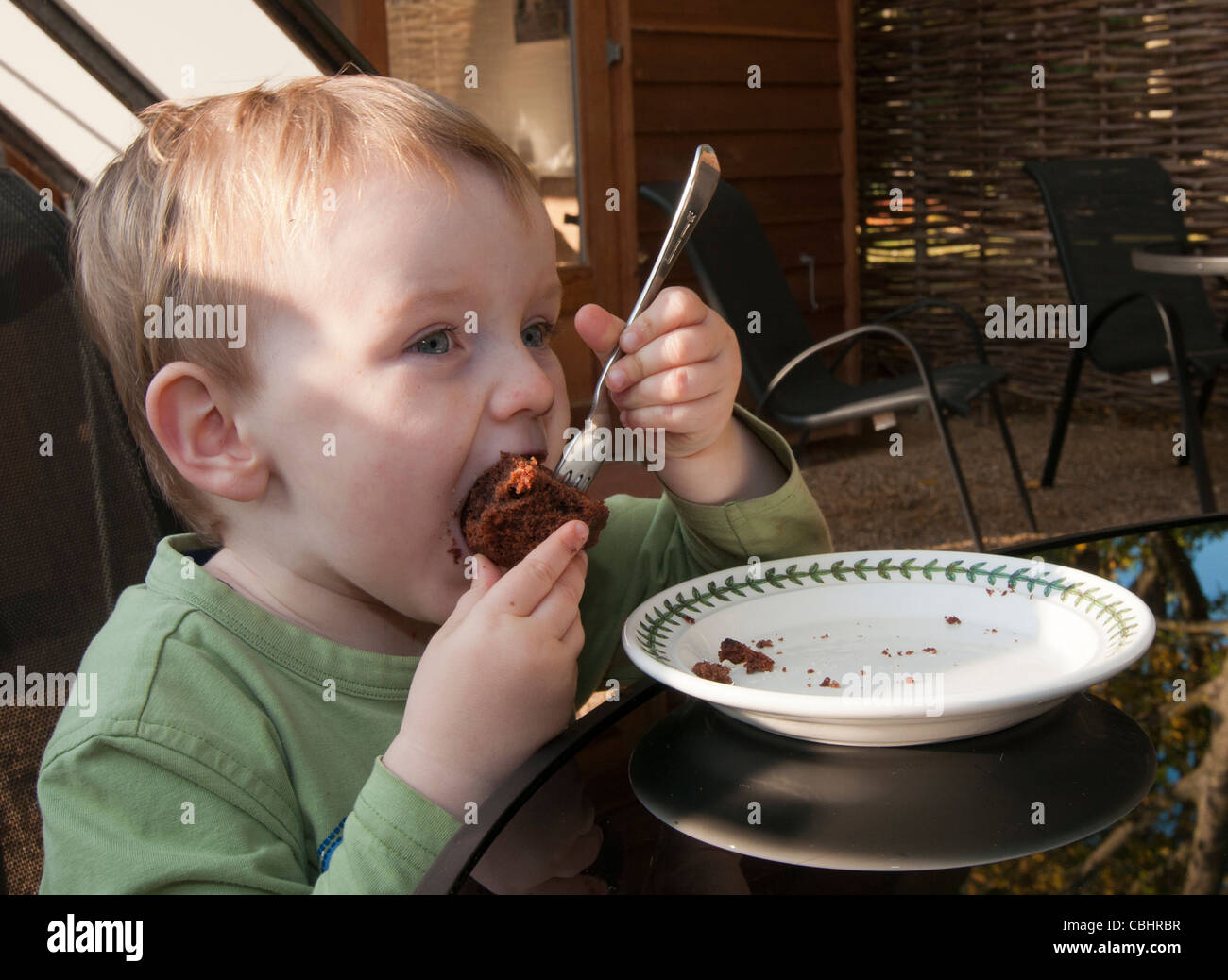 Small boy eating chocolate cake Stock Photo - Alamy