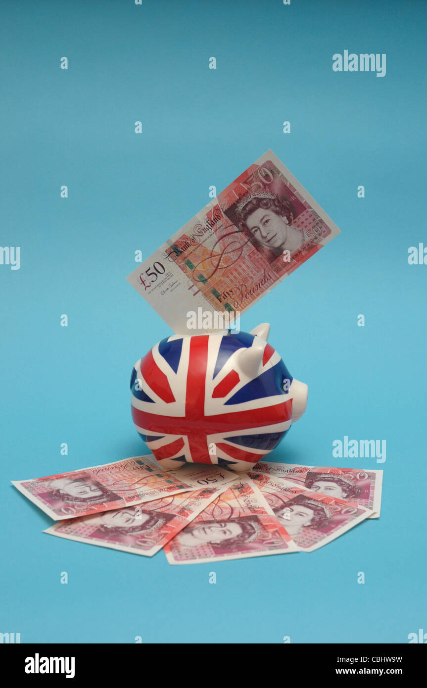 Debt Crisis. Union Jack Piggy Bank with a fan of fifty pound bank notes ...