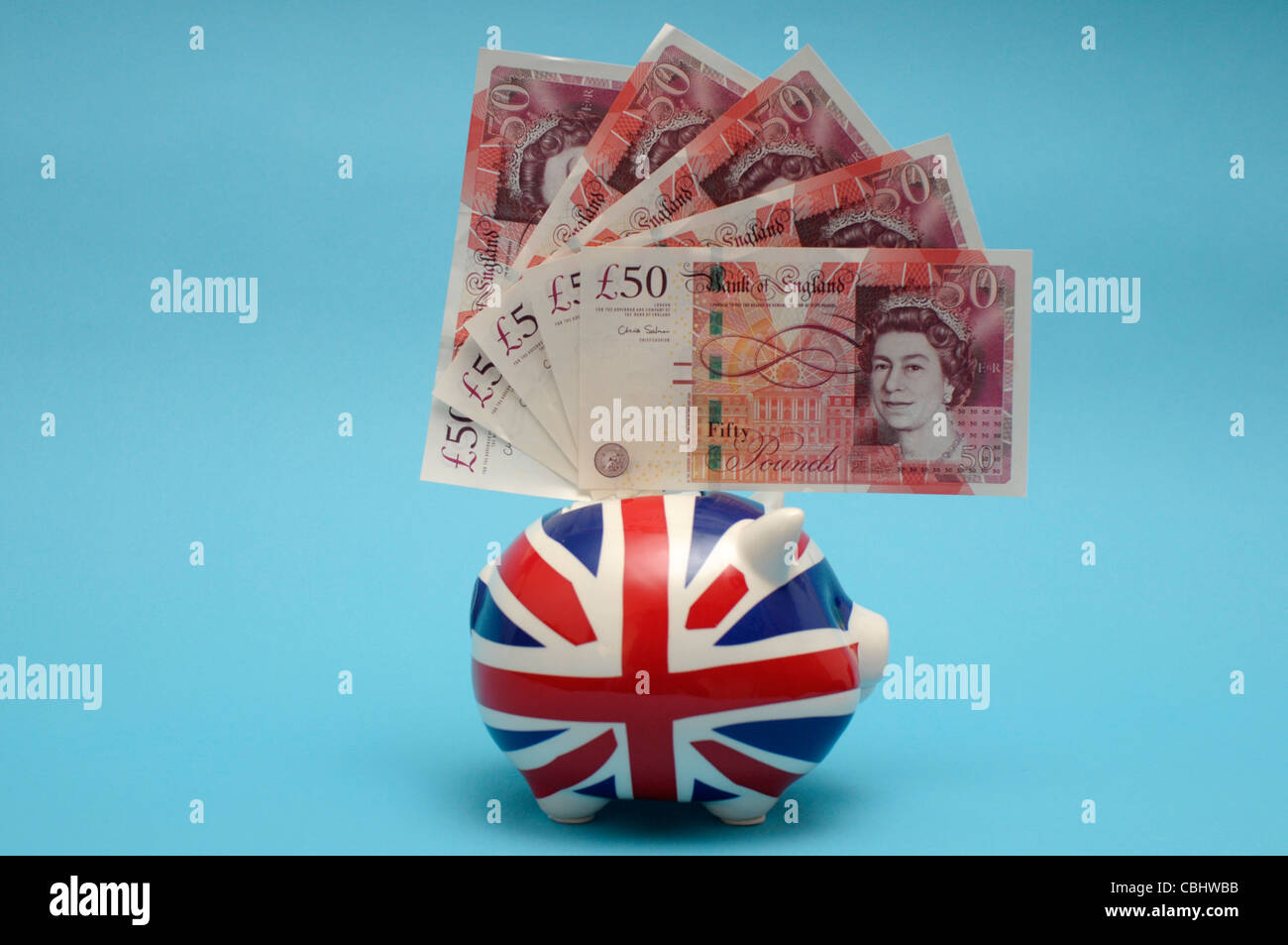 Debt Crisis. Union Jack Piggy Bank with a fan of fifty pound bank notes ...