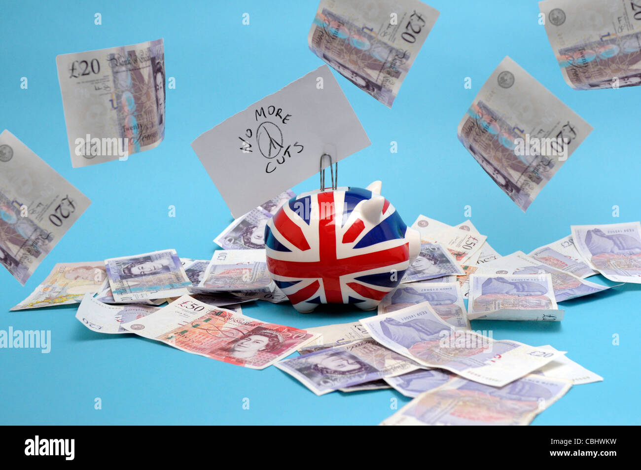 Money falling around a Union Jack Flag piggy bank against a blue ...