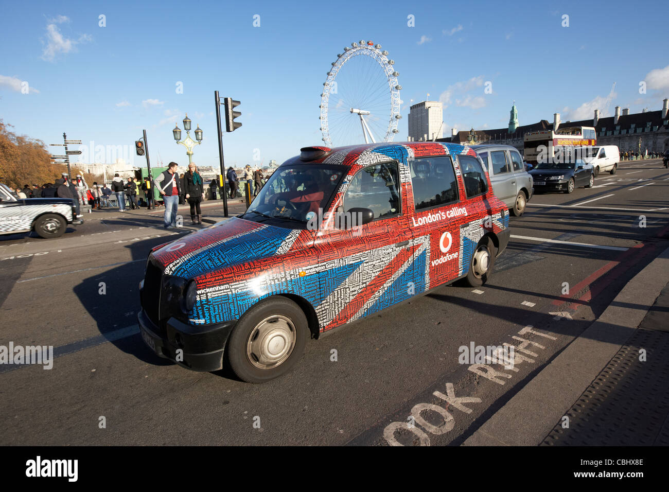 black london cab taxi with union flag advertising on westminster bridge ...