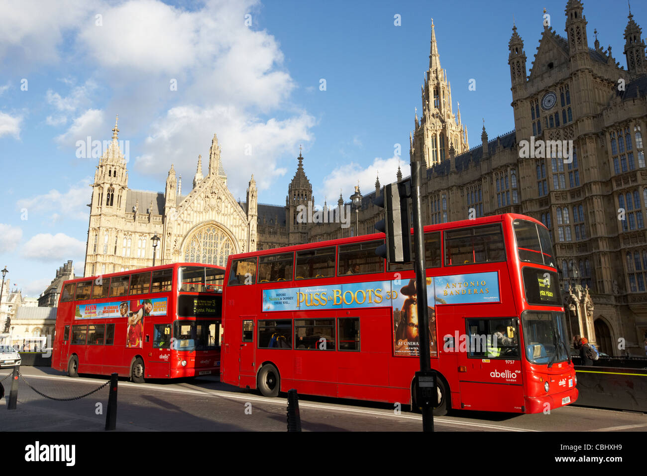 two london red double decker busses public transport outside the houses ...