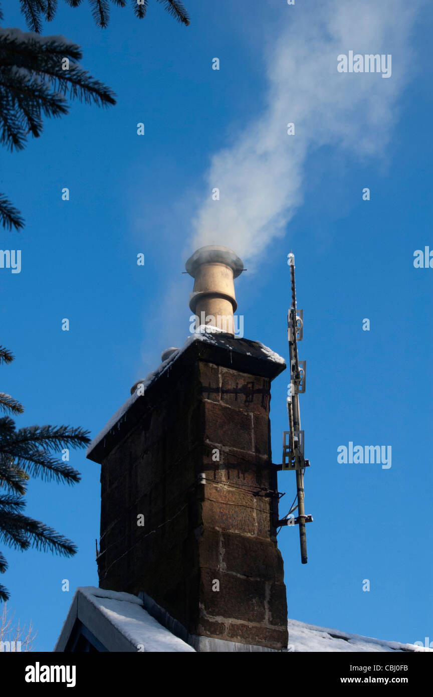 A smoking snow covered chimney Stock Photo - Alamy