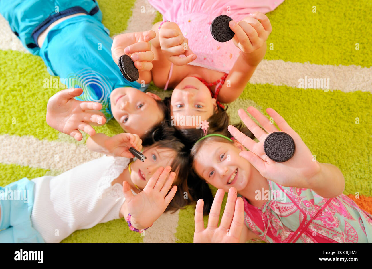 boy and girls playing with cookies Stock Photo - Alamy