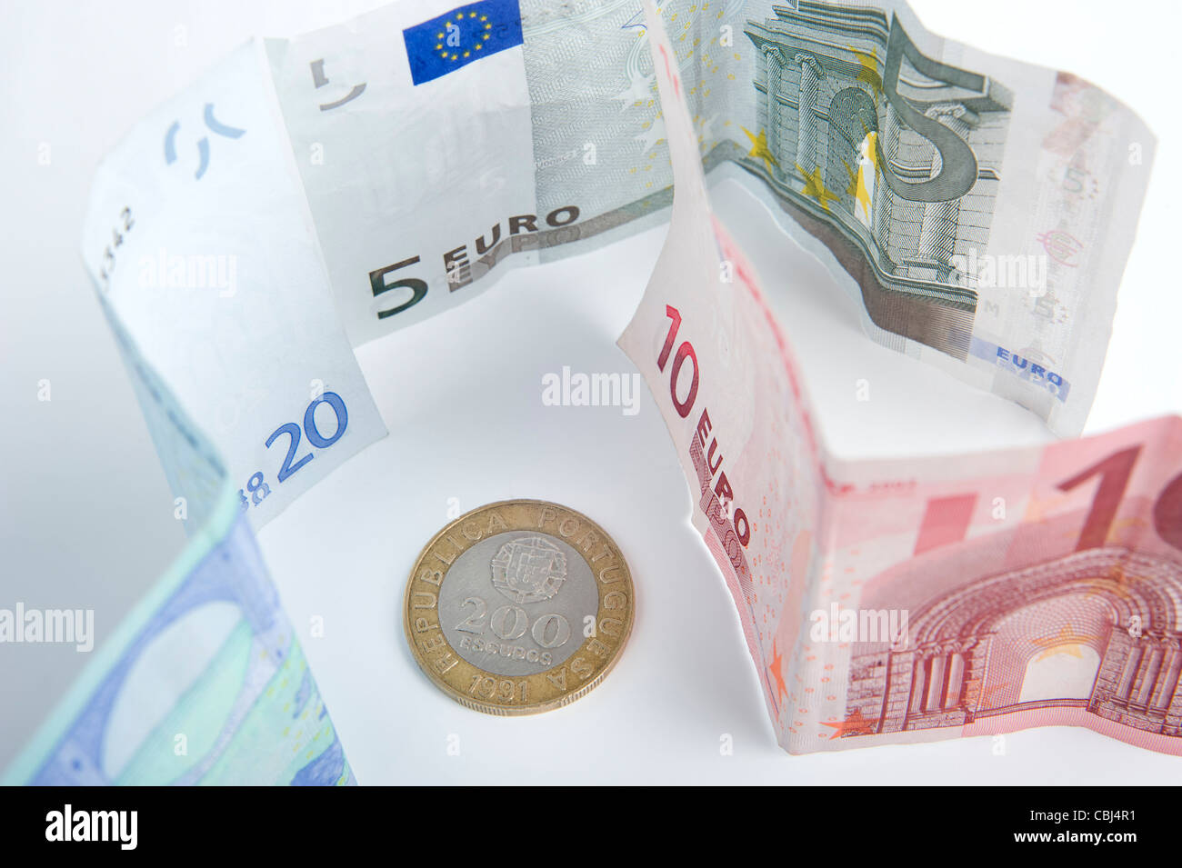 Old portuguese Escudo coin next to Euro bills Stock Photo - Alamy