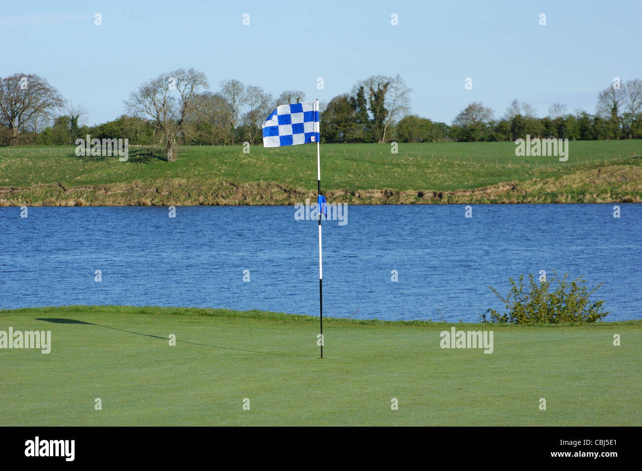 Golf flag and lake Stock Photo - Alamy