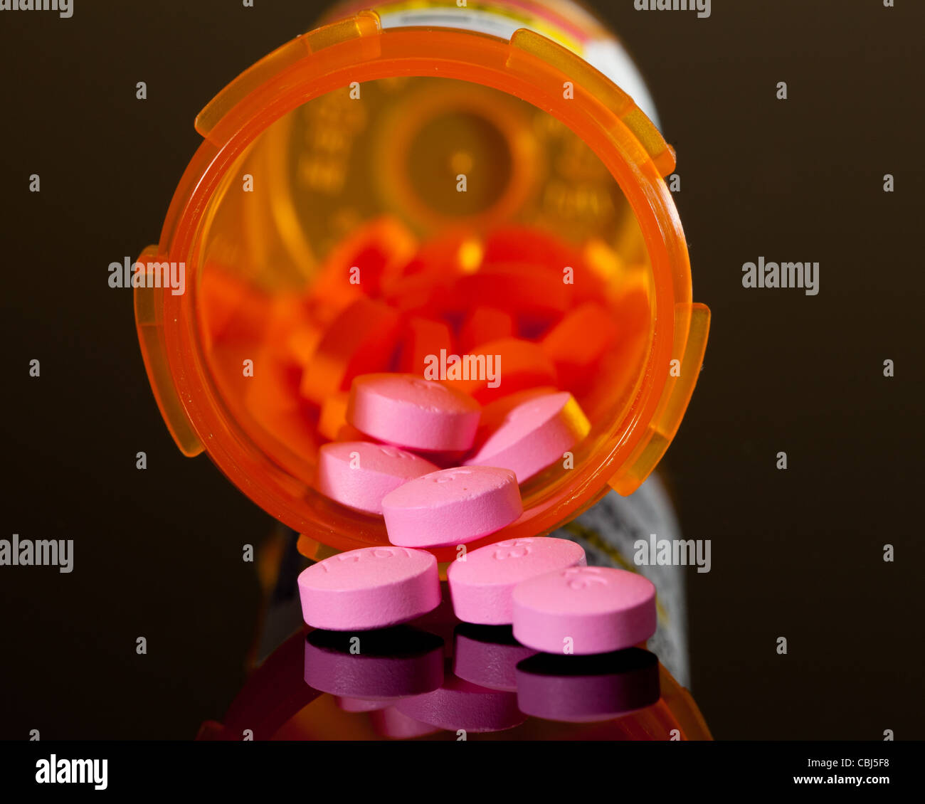 Set of round purple tablets pouring from an orange pill bottle Stock ...