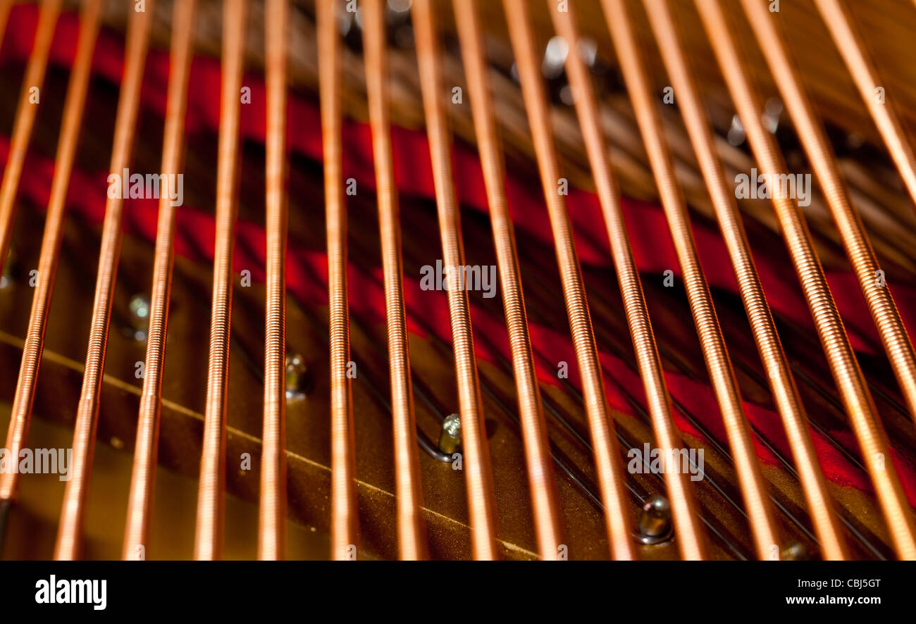 Close up image of interior of grand piano showing strings and structure ...