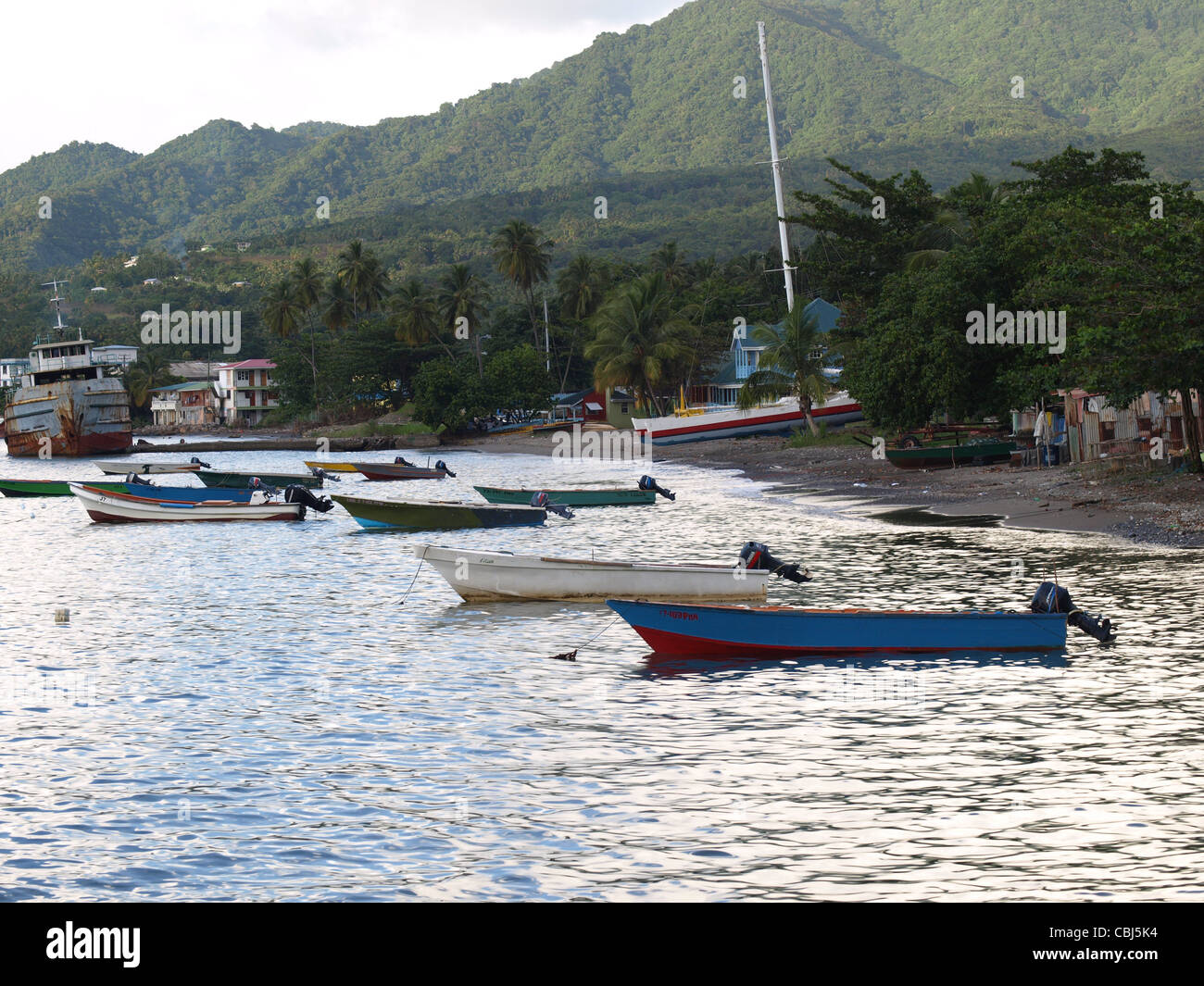 Fishing boats anchored along a beach in Portsmouth, Commonwealth of ...