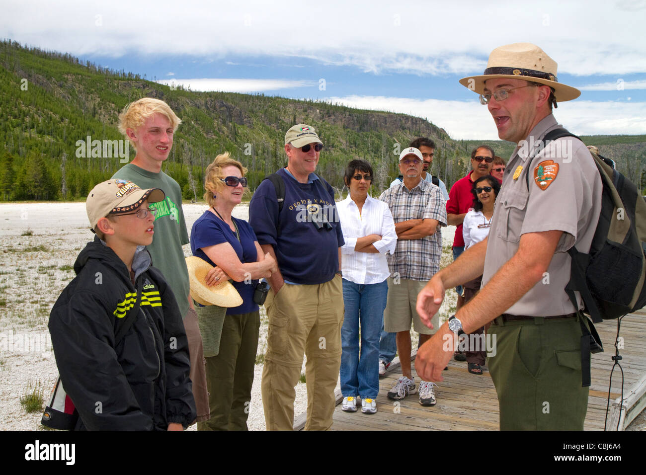 Park ranger giving a tour group information about the Upper Geyser ...