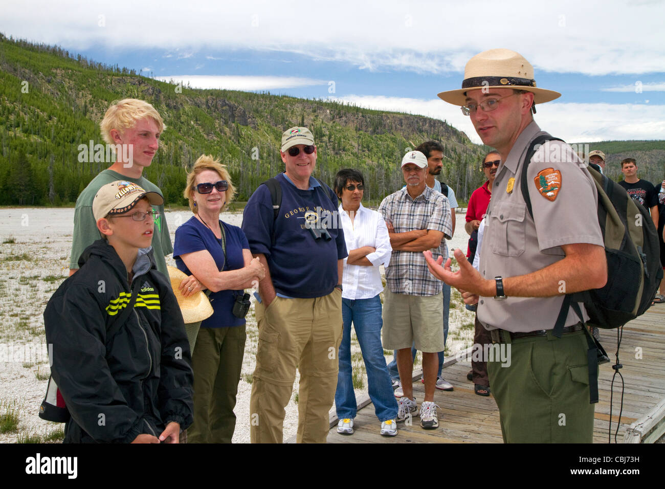 Park ranger giving a tour group information about the Upper Geyser ...