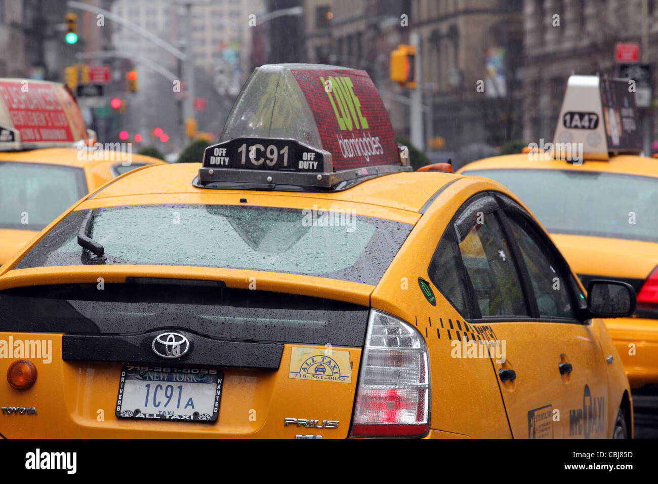 Yellow New York City taxi cabs heavy traffic & rain Flatiron district ...