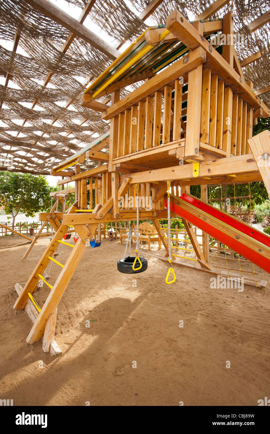 Childrens wooden climbing frame with slide in a playground at park ...