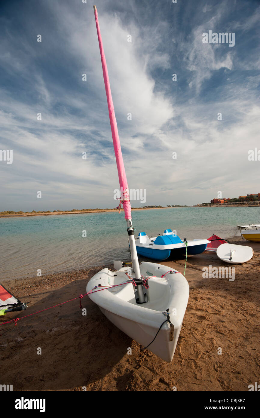 Small sailing dingy on a beach with an overcast sky background Stock ...