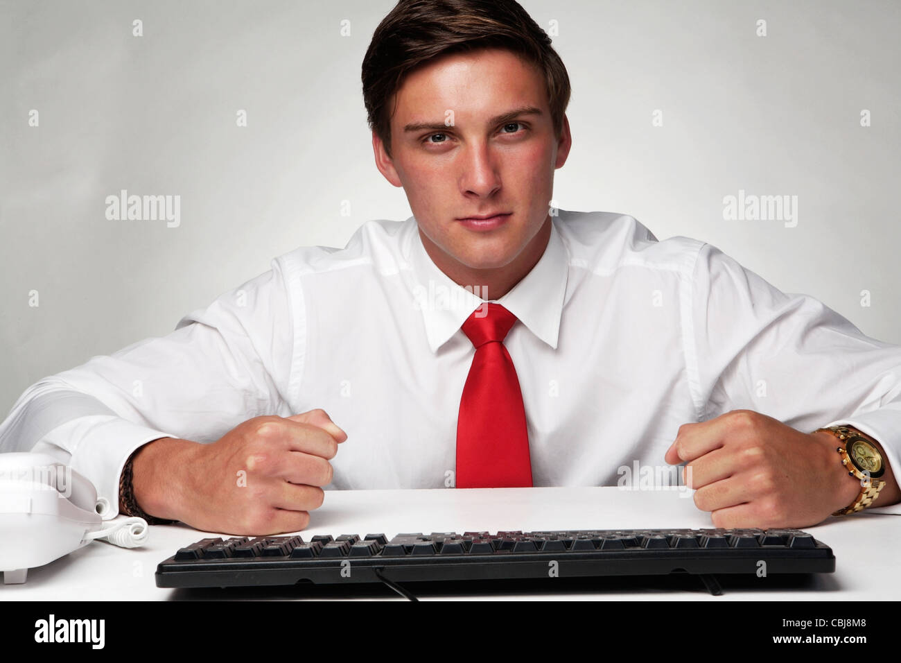 business man at hitting his desk and not very happy about something ...