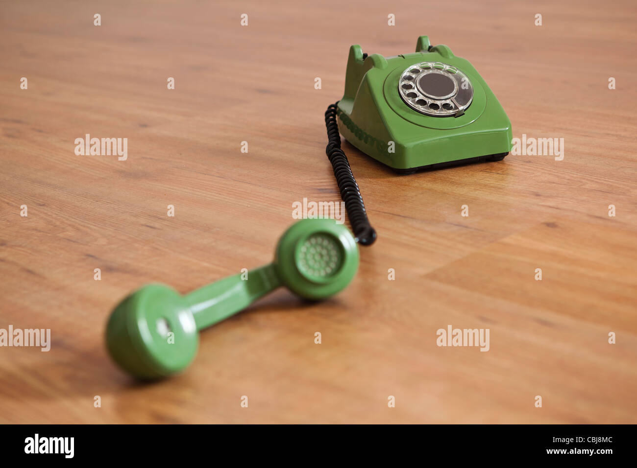Vintage green phone over a wood floor Stock Photo - Alamy