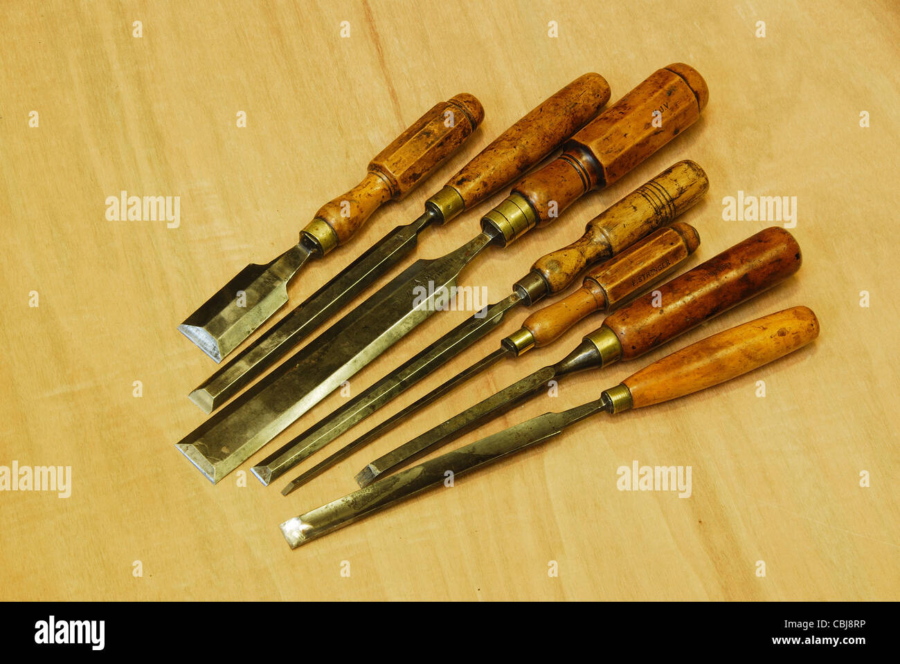 A collection of wooden handled chisels used for furniture restoration ...