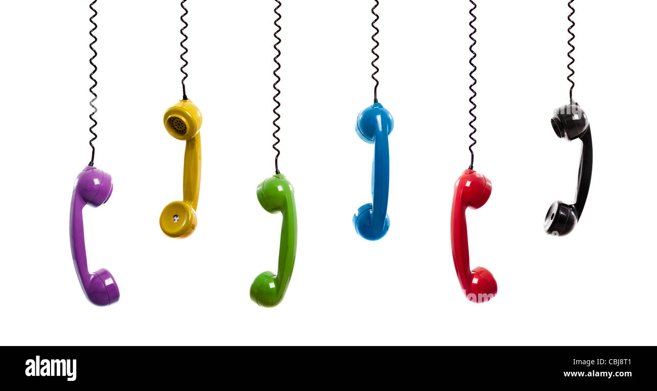 Multi colored handset pieces suspended by the phone cord, isolated on ...