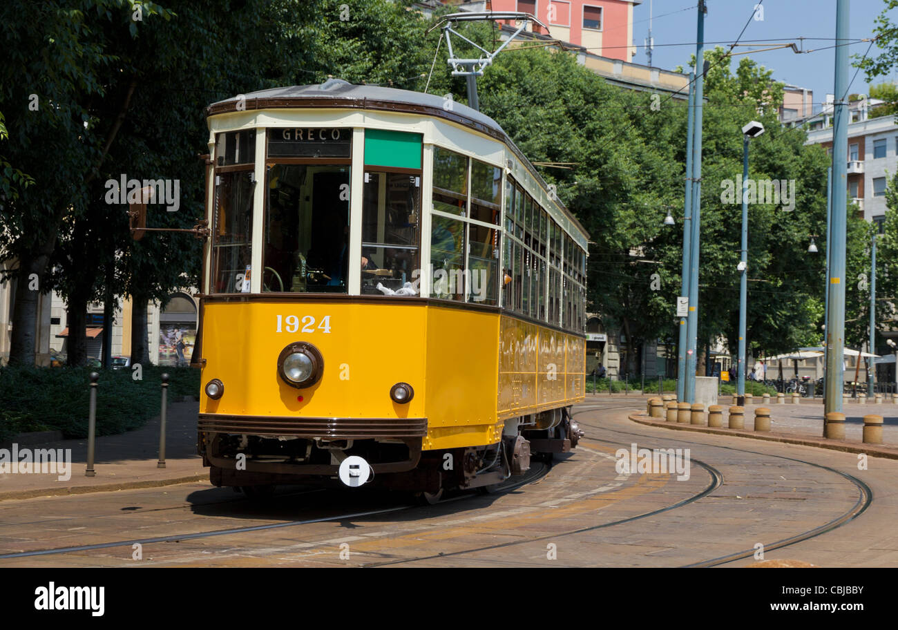 historic classic yellow tram of Milan on winding rails, Italy Stock ...