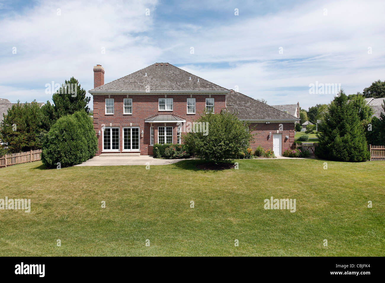Rear view of brick home with large back yard Stock Photo - Alamy