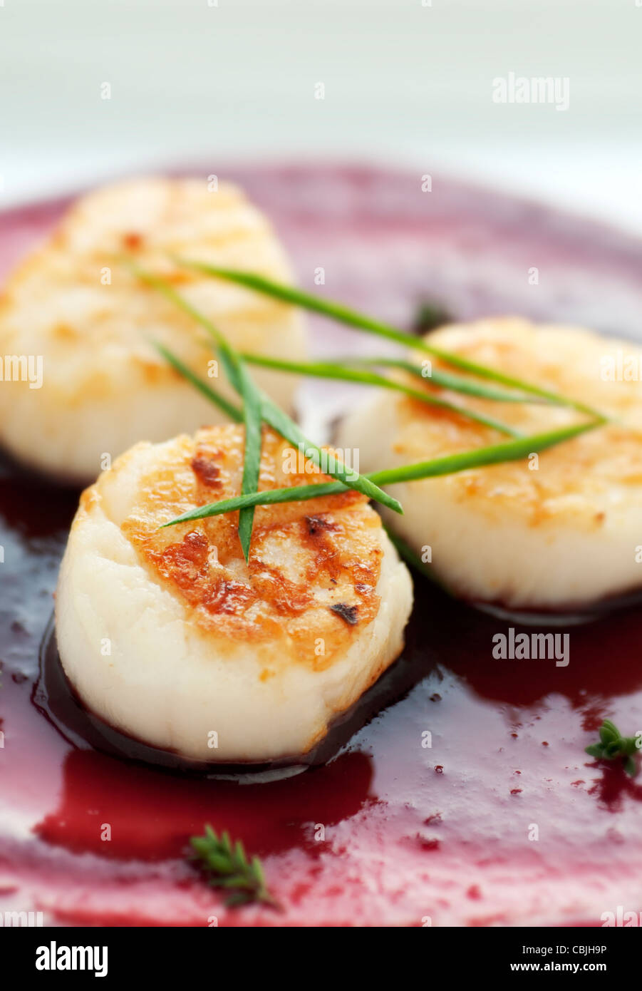 Perfectly seared scallop starter with bright cranberry and balsamic ...