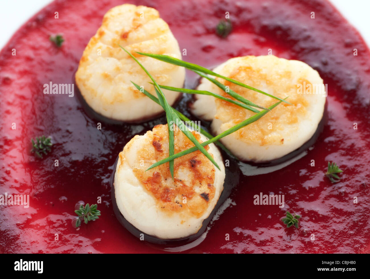 Perfectly seared scallop starter with bright cranberry and balsamic ...
