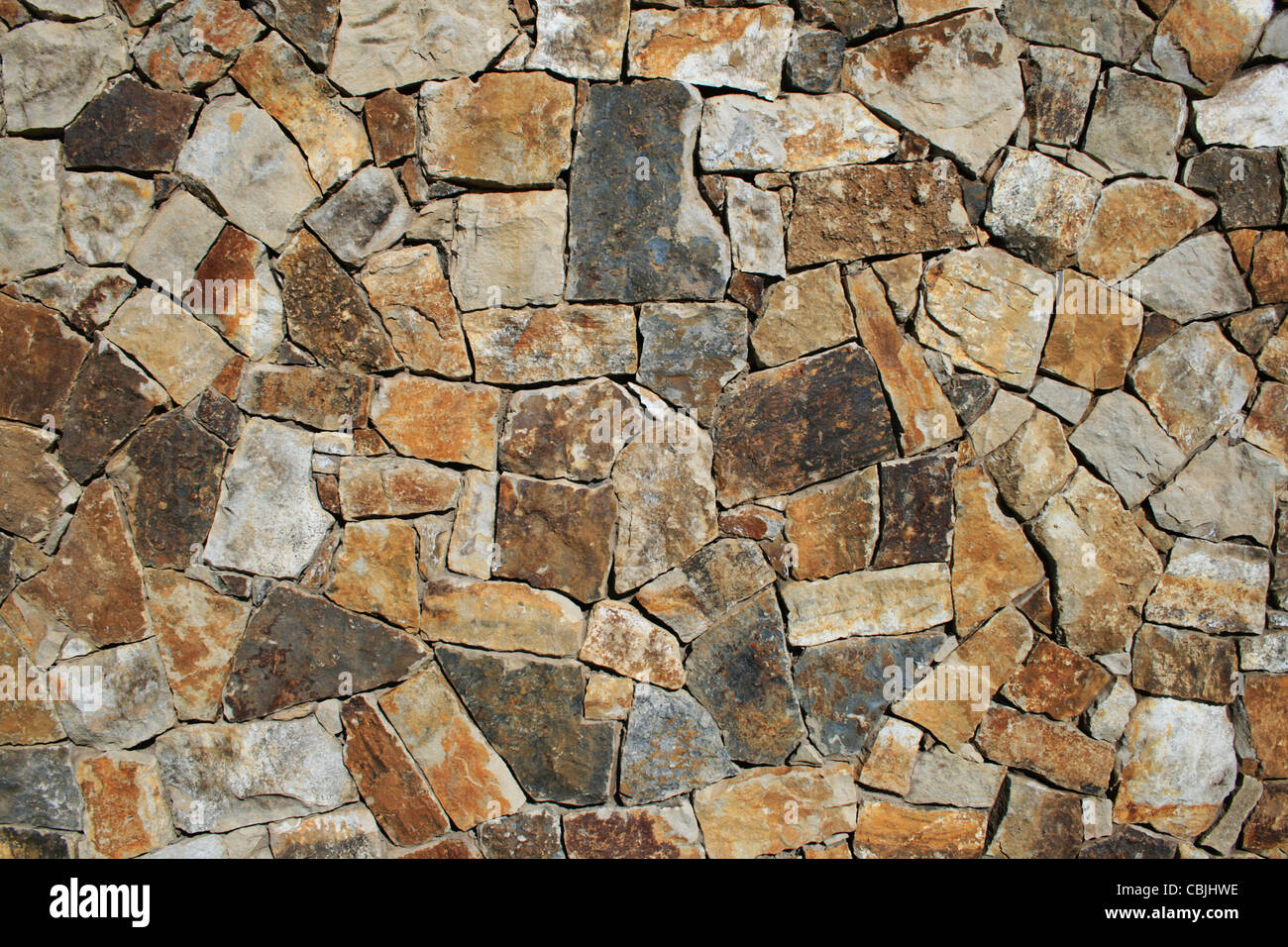 orange, gray, brown, and tan stone wall background Stock Photo - Alamy