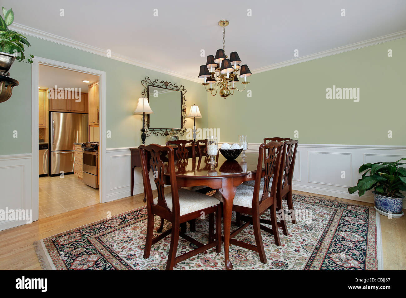 Dining room in suburban home with kitchen view Stock Photo - Alamy