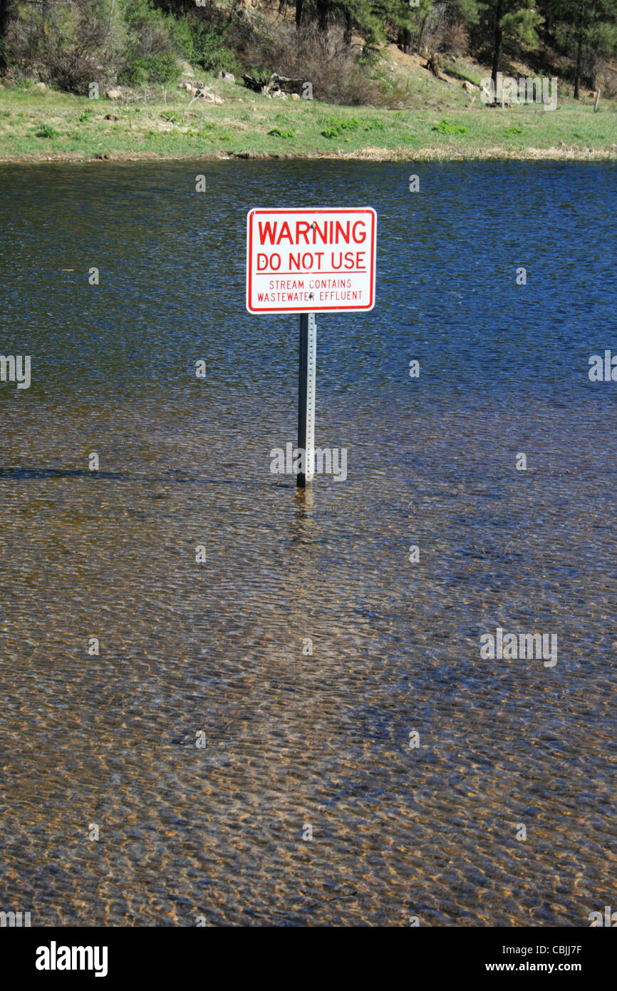 warning sign on water for wastewater effluent Stock Photo - Alamy