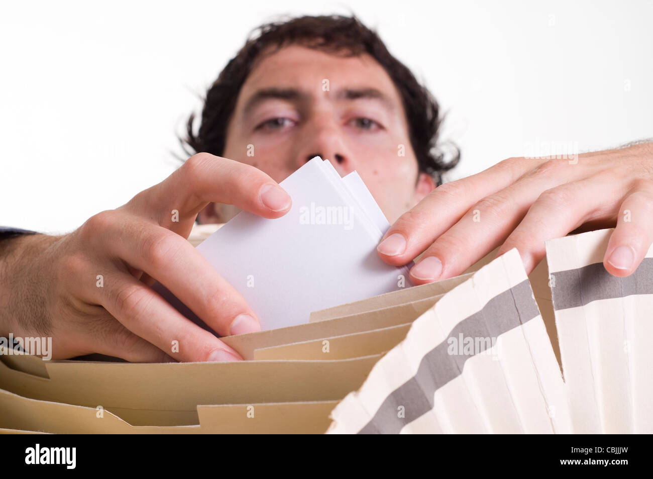 Man reaching and sorting through files Stock Photo - Alamy