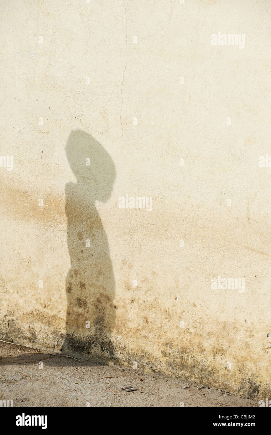 Young rural Indian village boys shadow on a sun lit wall. India Stock ...