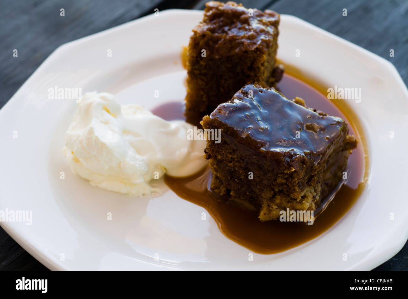 sticky toffee pudding with ice cream and spoons Stock Photo - Alamy