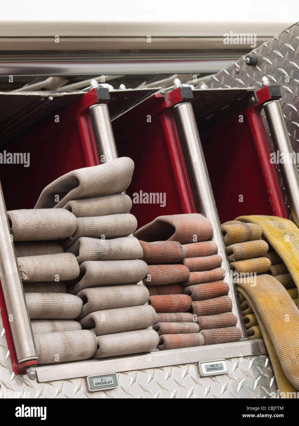Fire hoses folded in fire truck Stock Photo - Alamy