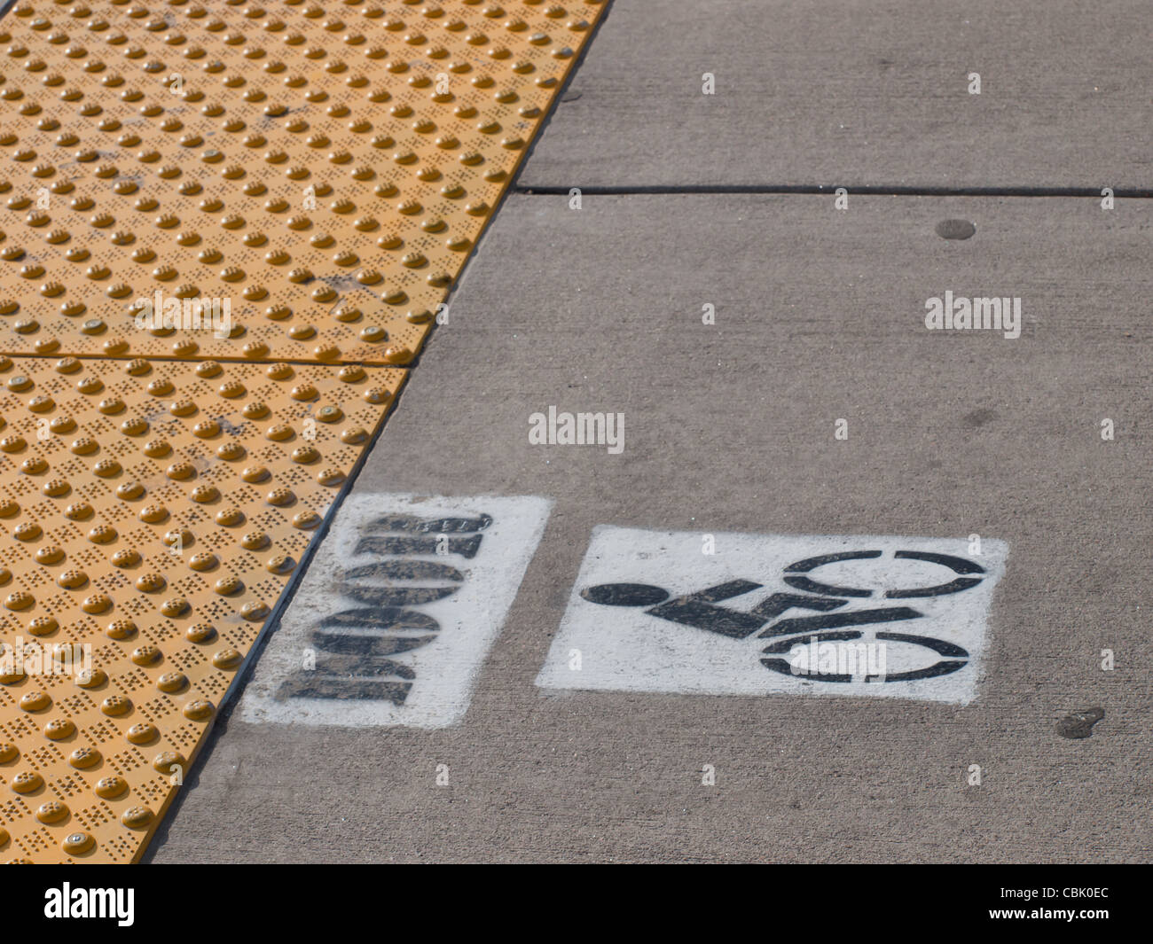 Signs for light rail train door location painted on the asphalt in ...