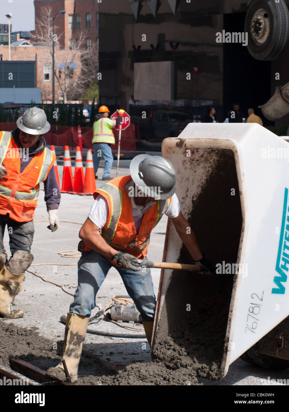 Road construction worker on new concrete road in downtown Denver ...
