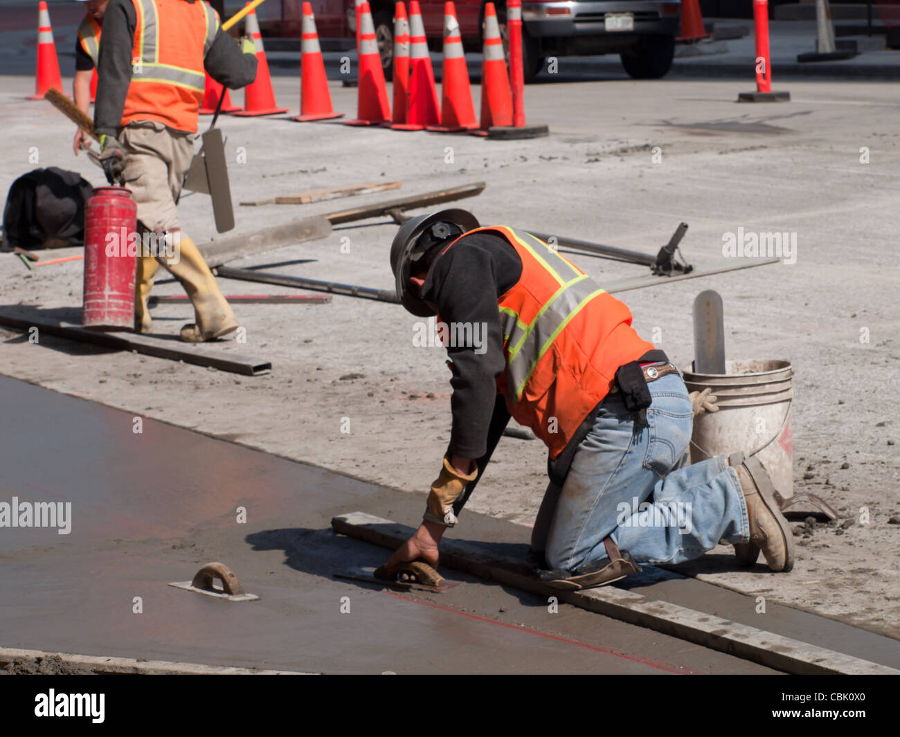 Road construction worker on new concrete road in downtown Denver ...
