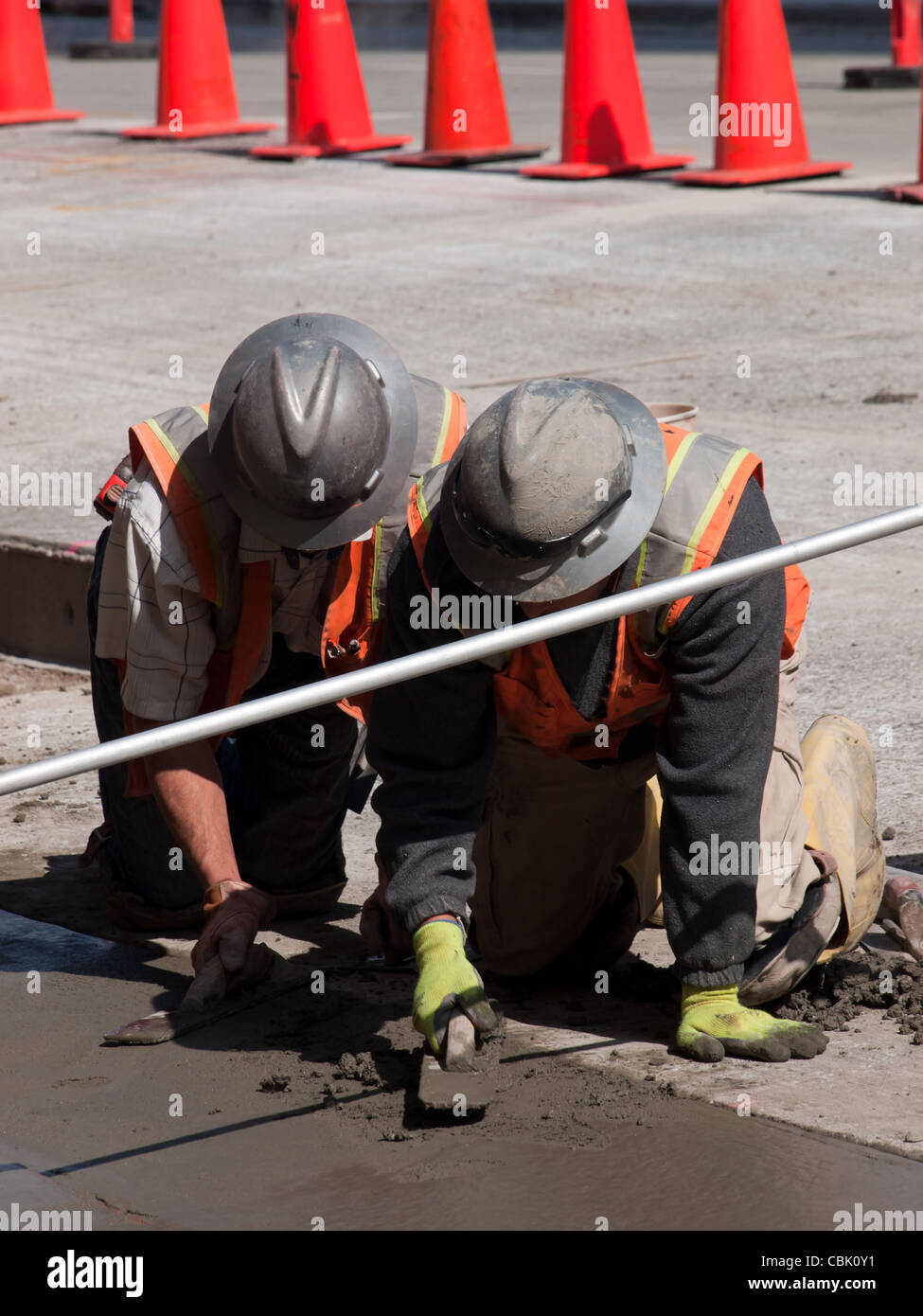 Road construction worker on new concrete road in downtown Denver ...