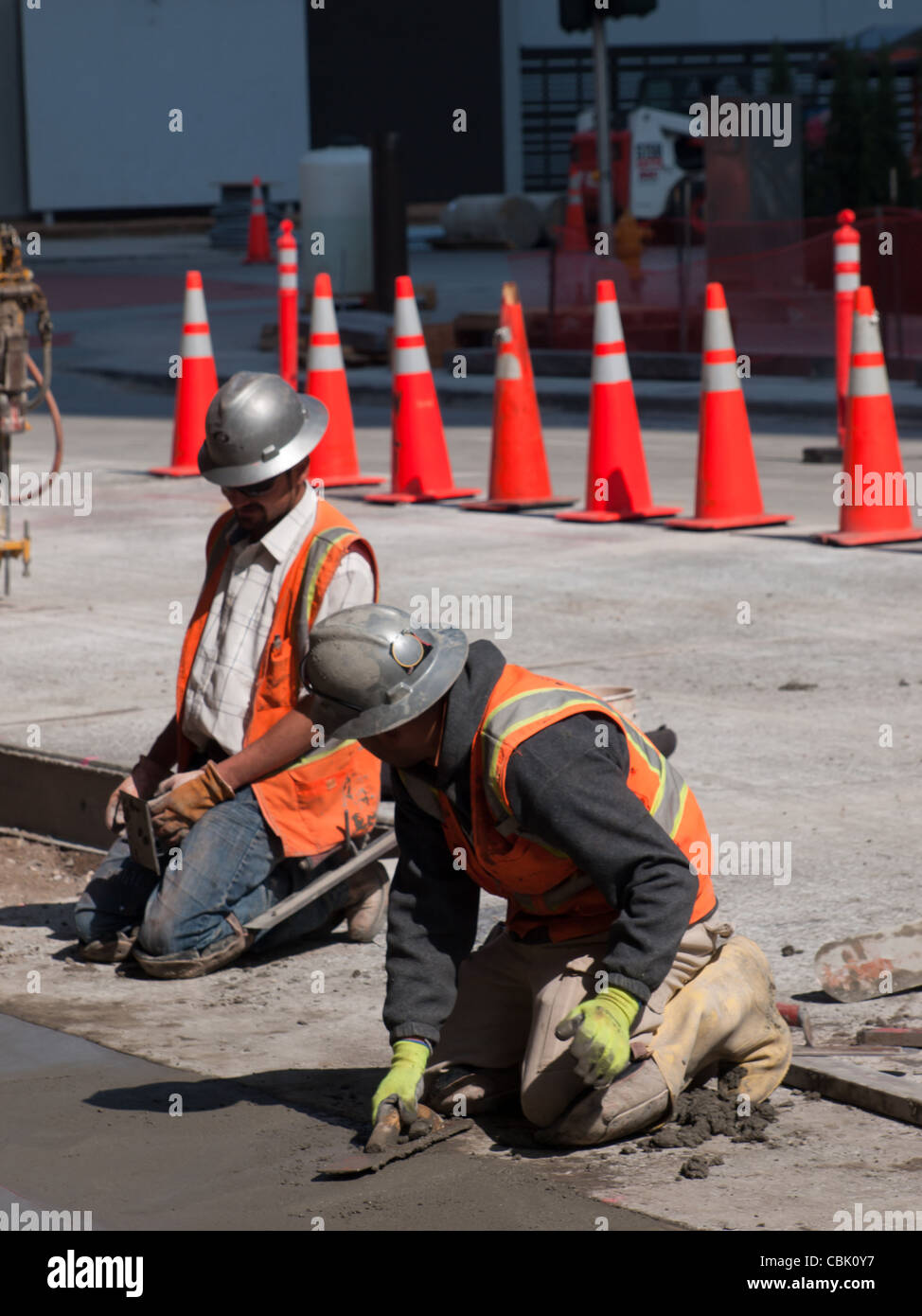 Road construction worker on new concrete road in downtown Denver ...