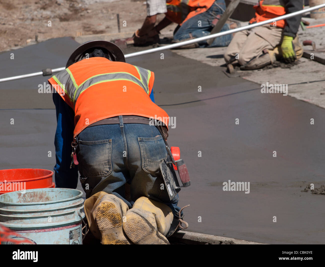 Road construction worker on new concrete road in downtown Denver ...