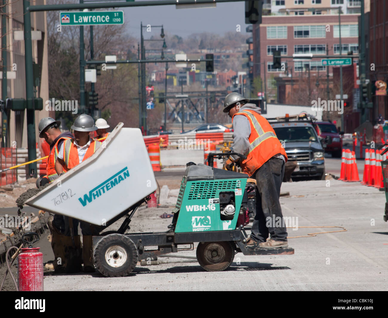 Road construction worker on new concrete road in downtown Denver ...