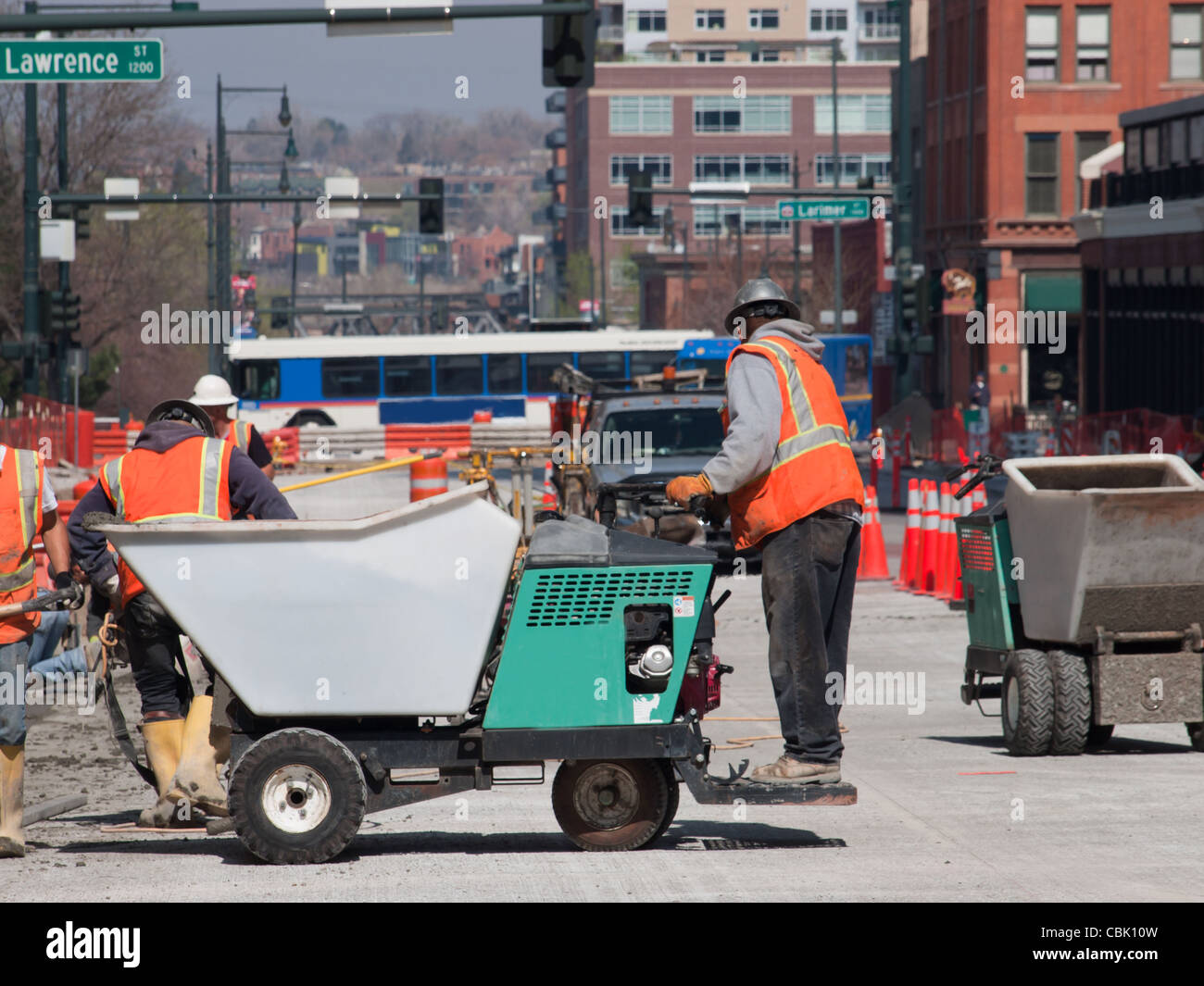 Road construction worker on new concrete road in downtown Denver ...